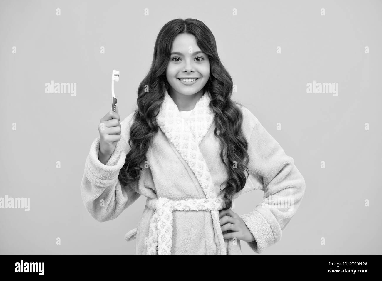 Morning brushing teeth. Teenager girl brushing her teeth over isolated ...