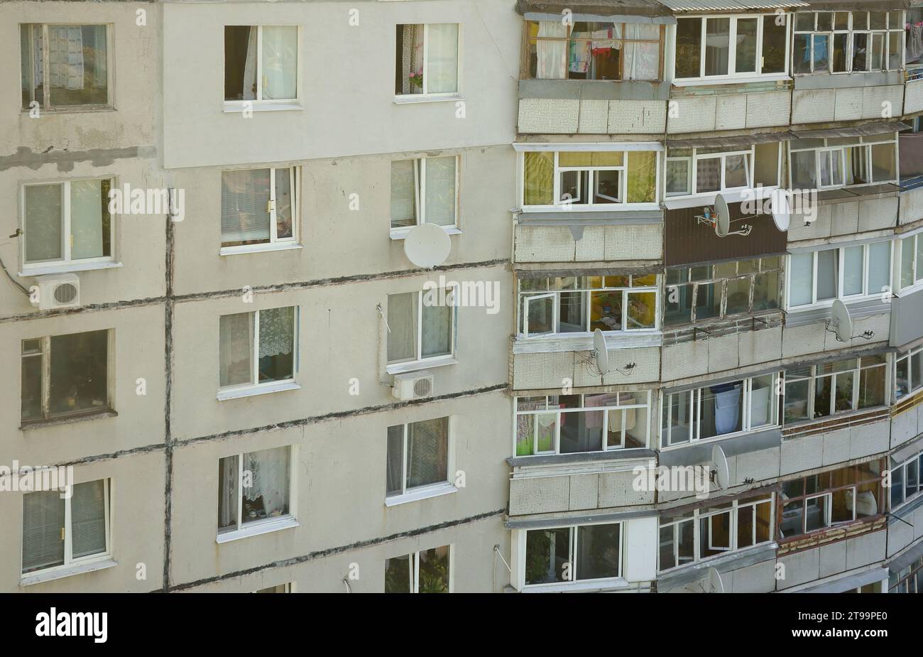 Facade of a grey multi storey soviet panel building. Russian old urban ...