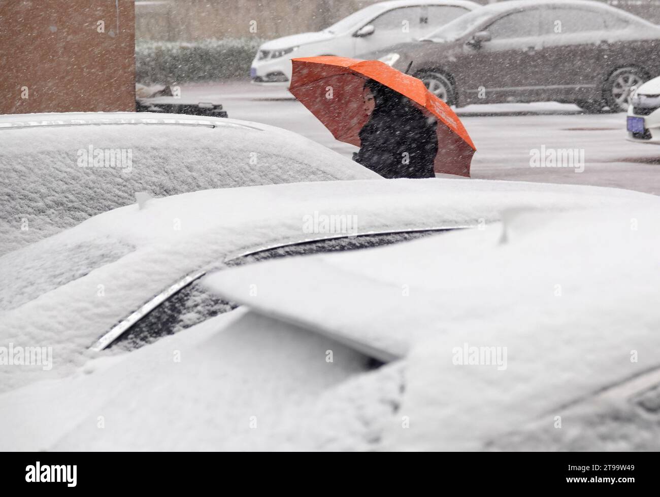 YANTAI, CHINA - NOVEMBER 24, 2023 - People brave snow on the streets of ...