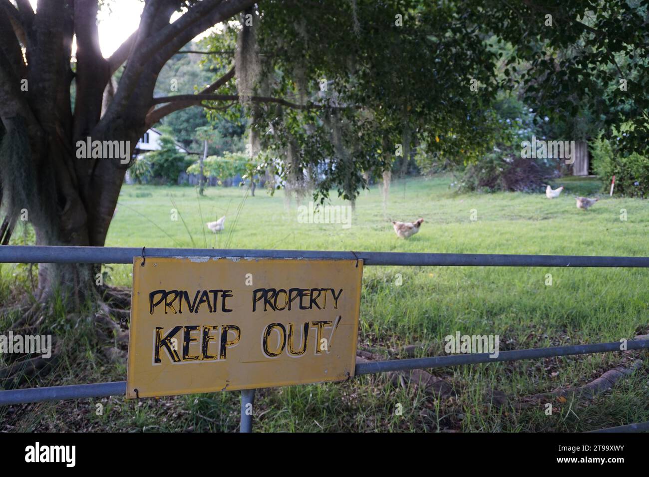 Rural scene with private property keep out sign on fence gate with ...