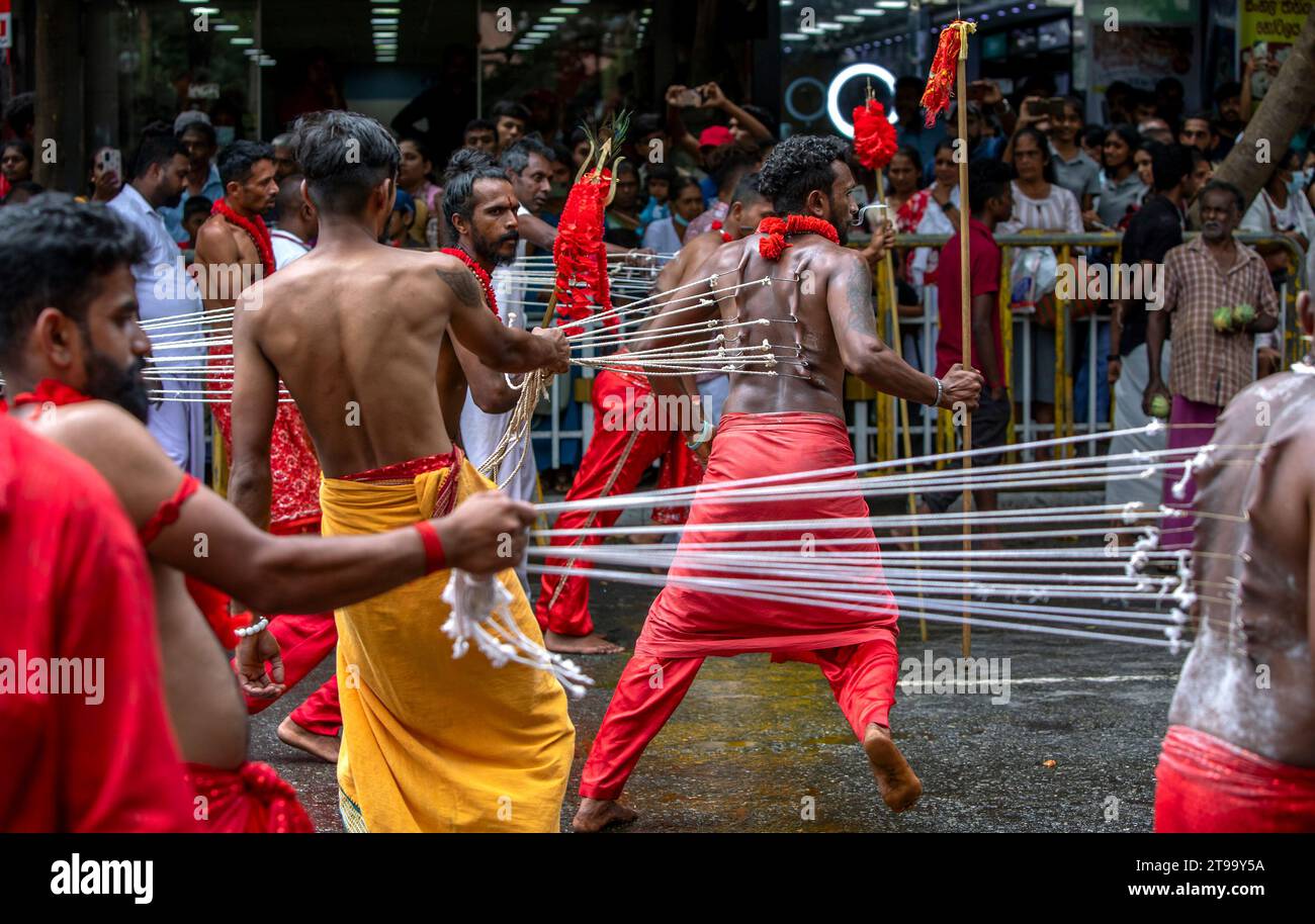 Hindu Kavadi Dancers with hooks piercing their skin perform along the ...