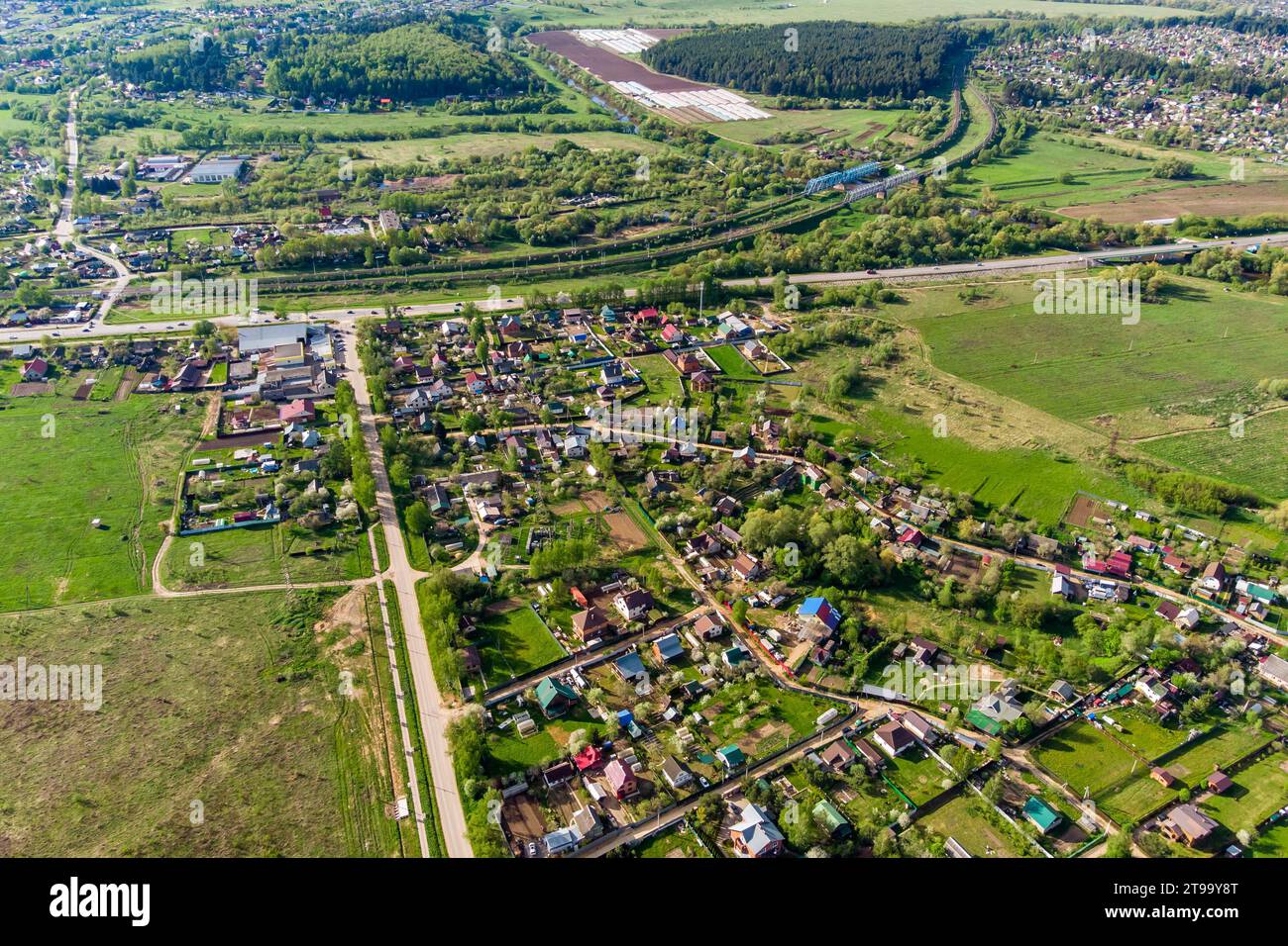 Aerial view of rural development near the road and the railway line in ...