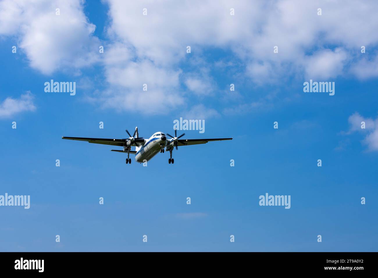 Plane in flight on blue sky Stock Photo - Alamy
