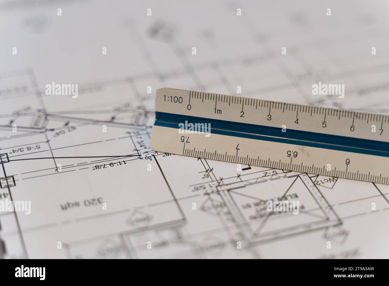 Architectural Scale Ruler with paper blueprints plans for new building ...
