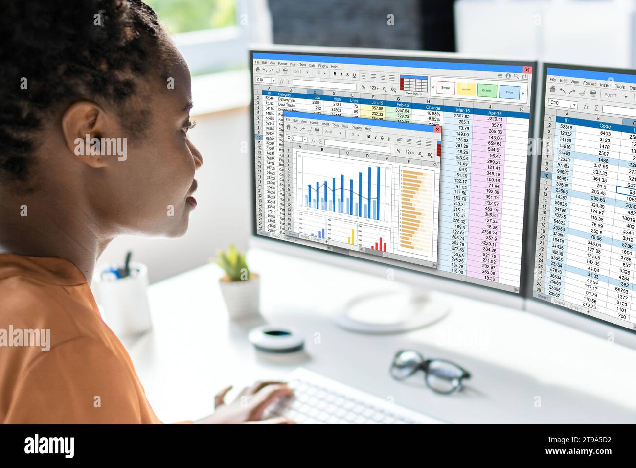 African woman analyst conducting data analysis on spreadsheets Stock ...
