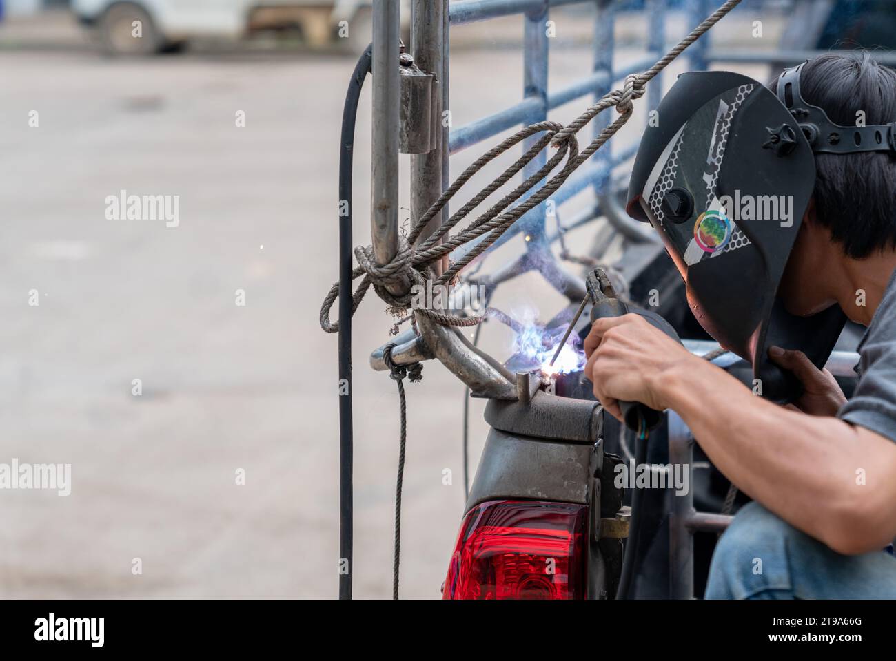 Technician welding edge truck stall for fix it in workshop Stock Photo ...
