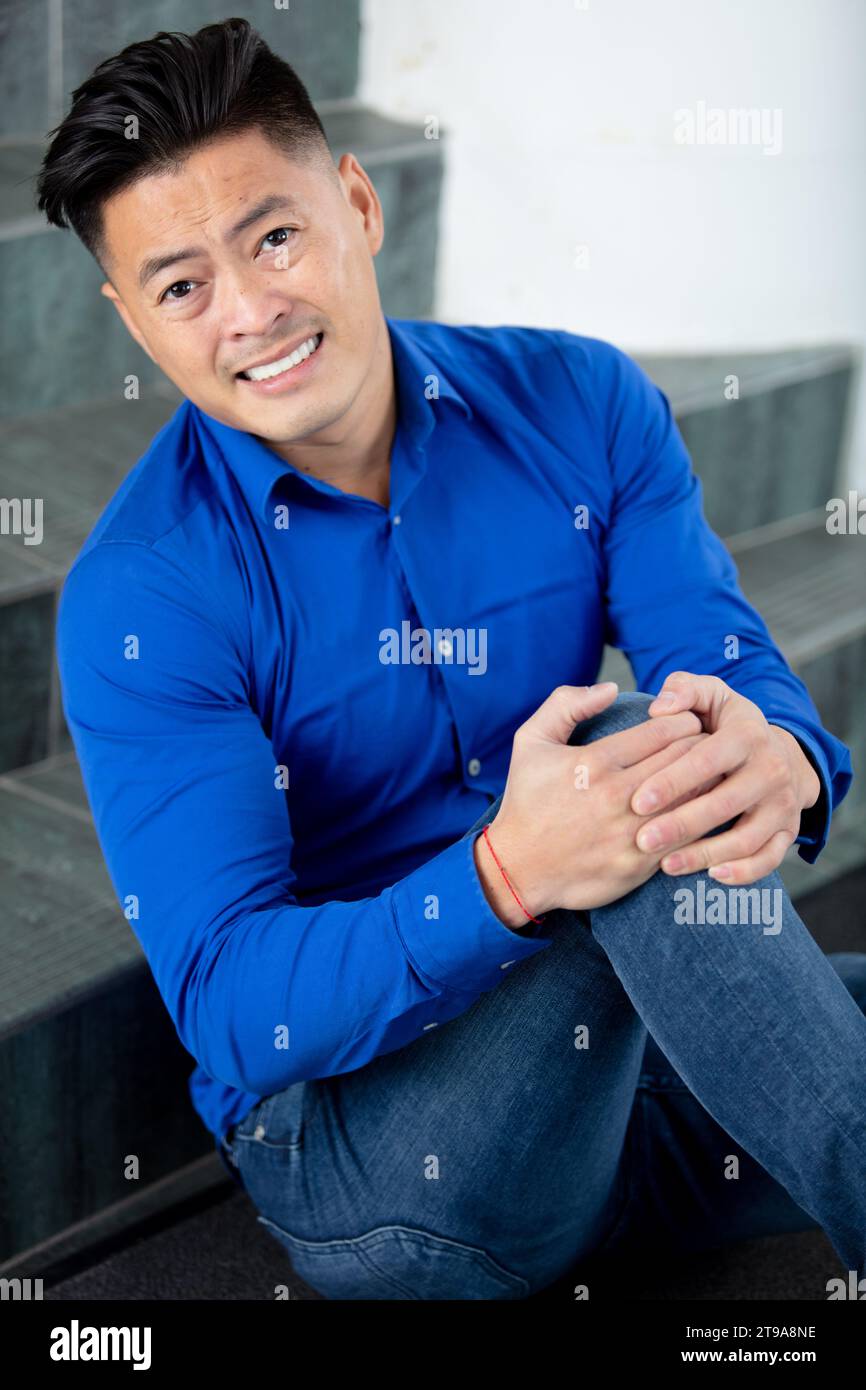 asian fall has fallen down stairs and injured his knee Stock Photo - Alamy