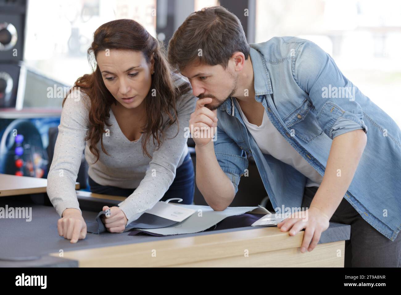 they are choosing furniture materials for her apartment Stock Photo - Alamy