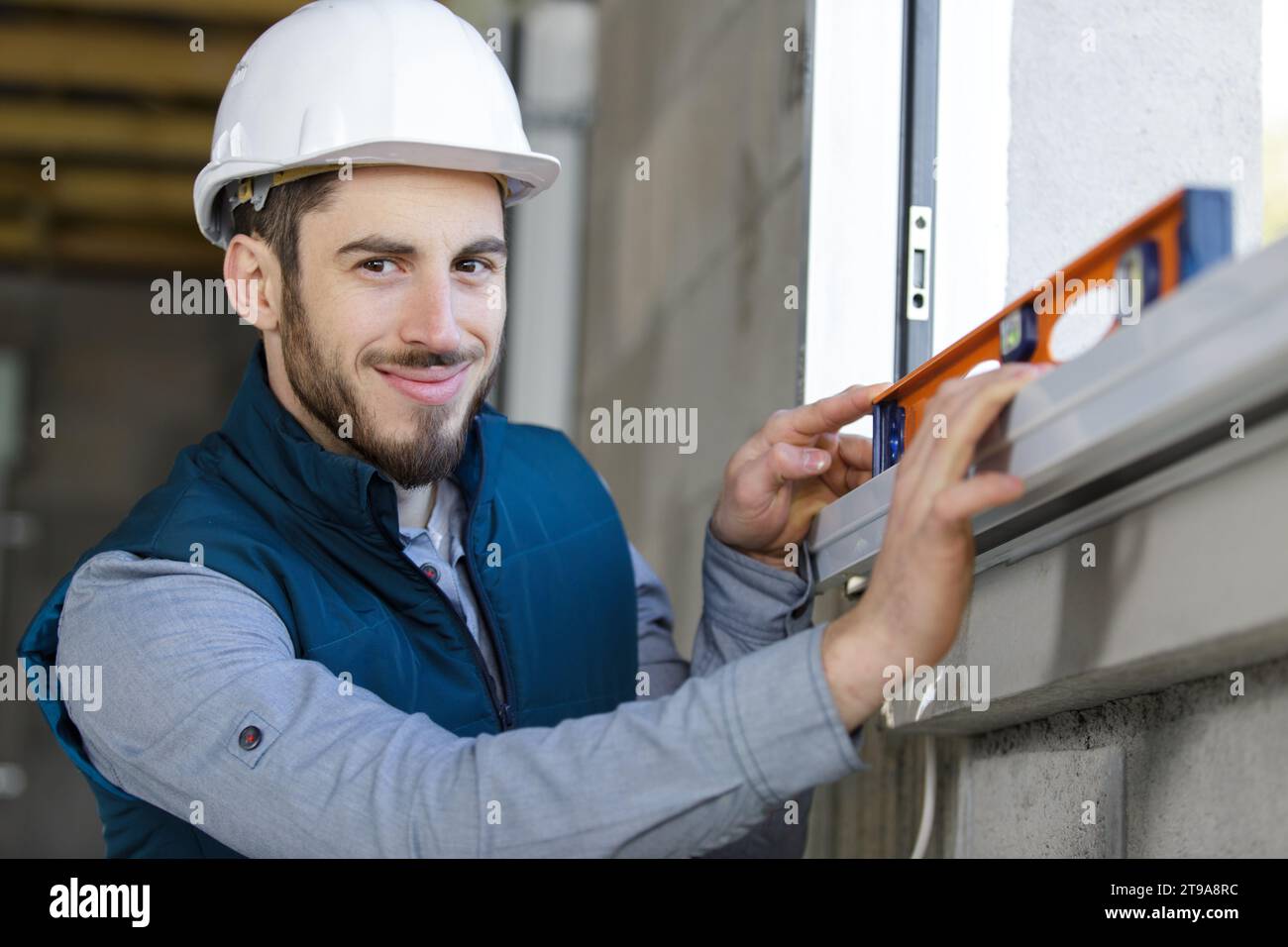 happy smiling constructor holding tool Stock Photo - Alamy