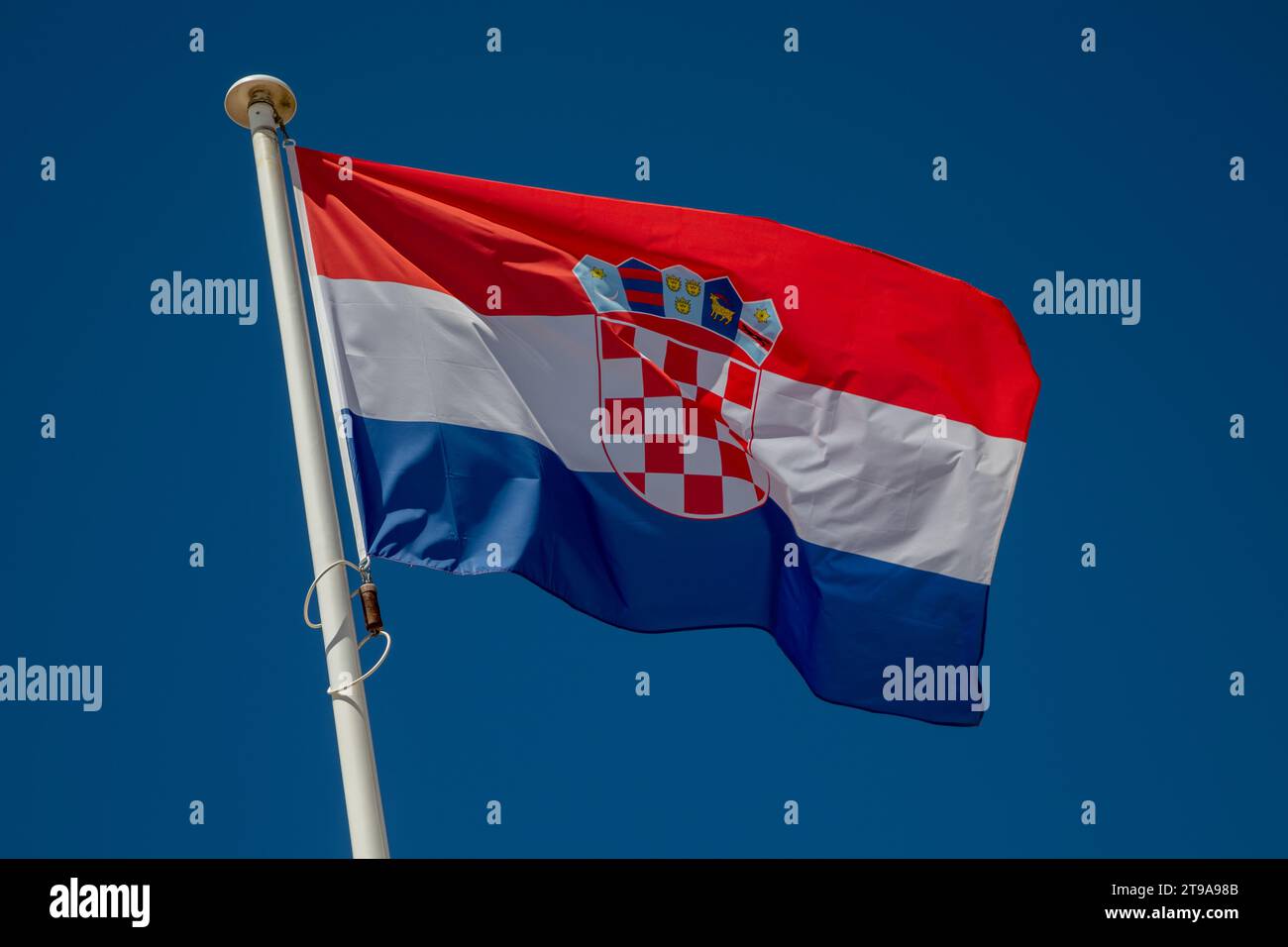 Croatia flag waving against clean blue sky isolated in red white blue ...