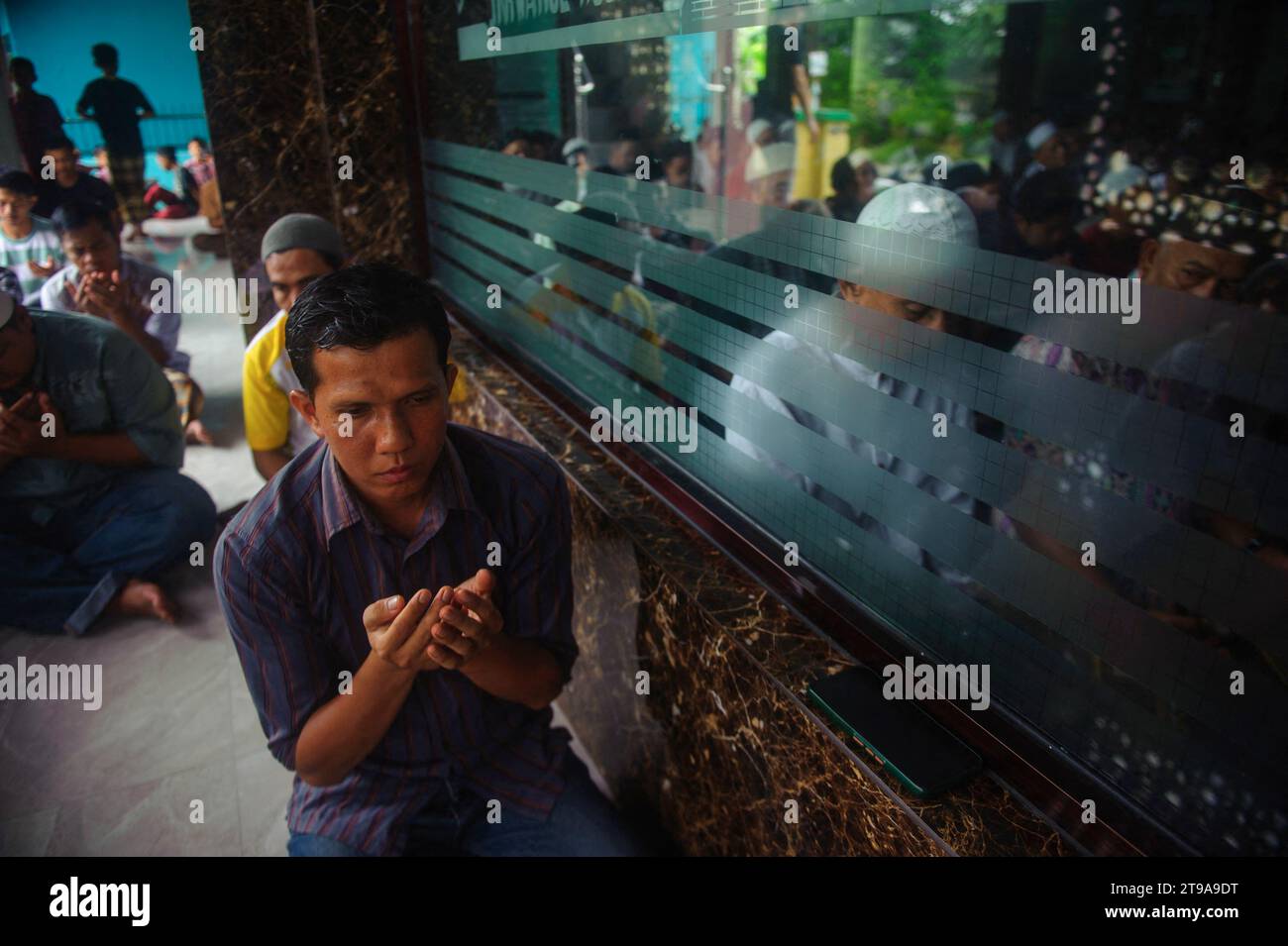 Muslim men are seen during Friday prayers at the Ikhwanul Muslimin ...