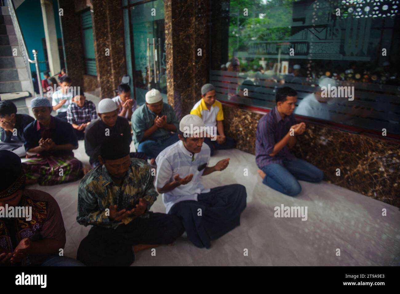 Muslim men are seen during Friday prayers at the Ikhwanul Muslimin ...