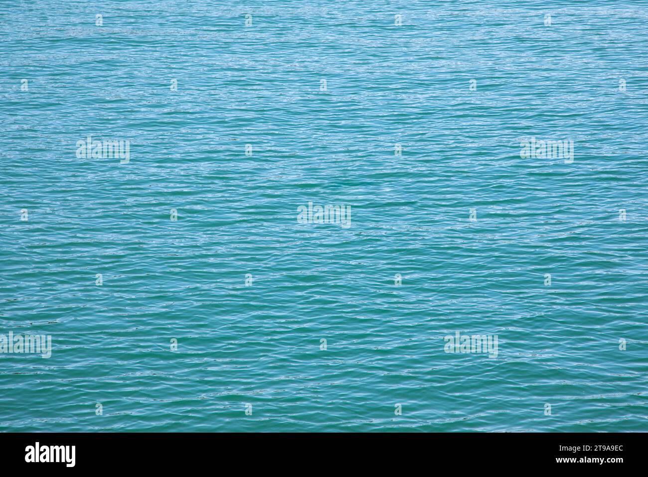 sea water background in light blue wavelets for wallpaper Stock Photo ...