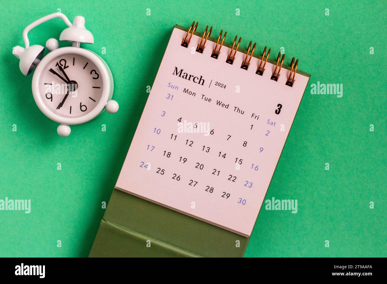 Calendar for March 2024. Desk calendar and clock for planning on a ...