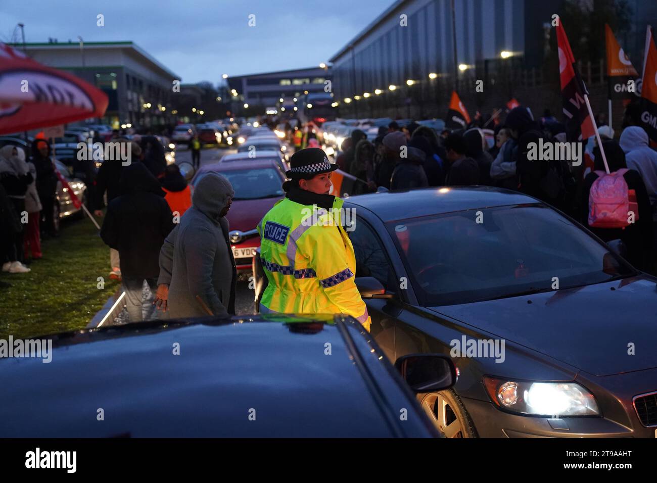 A police officer monitors Amazon staff members on a GMB union picket ...