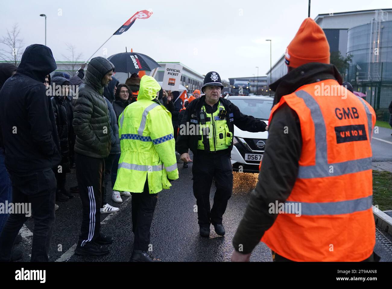 A police officer speaks to Amazon staff members on a GMB union picket ...