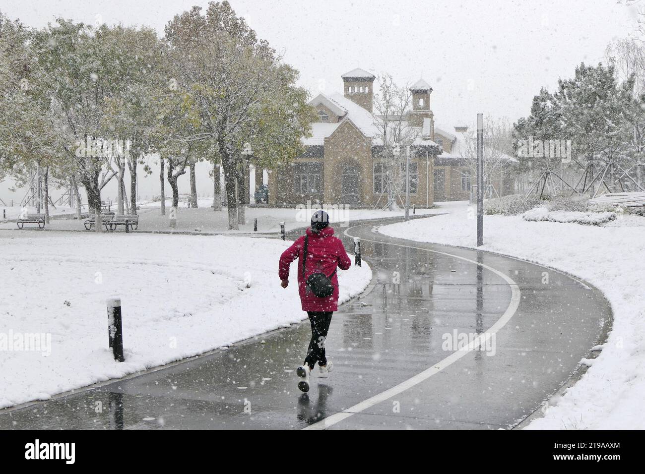 YANTAI, CHINA - NOVEMBER 24, 2023 - People brave snow on the streets of ...