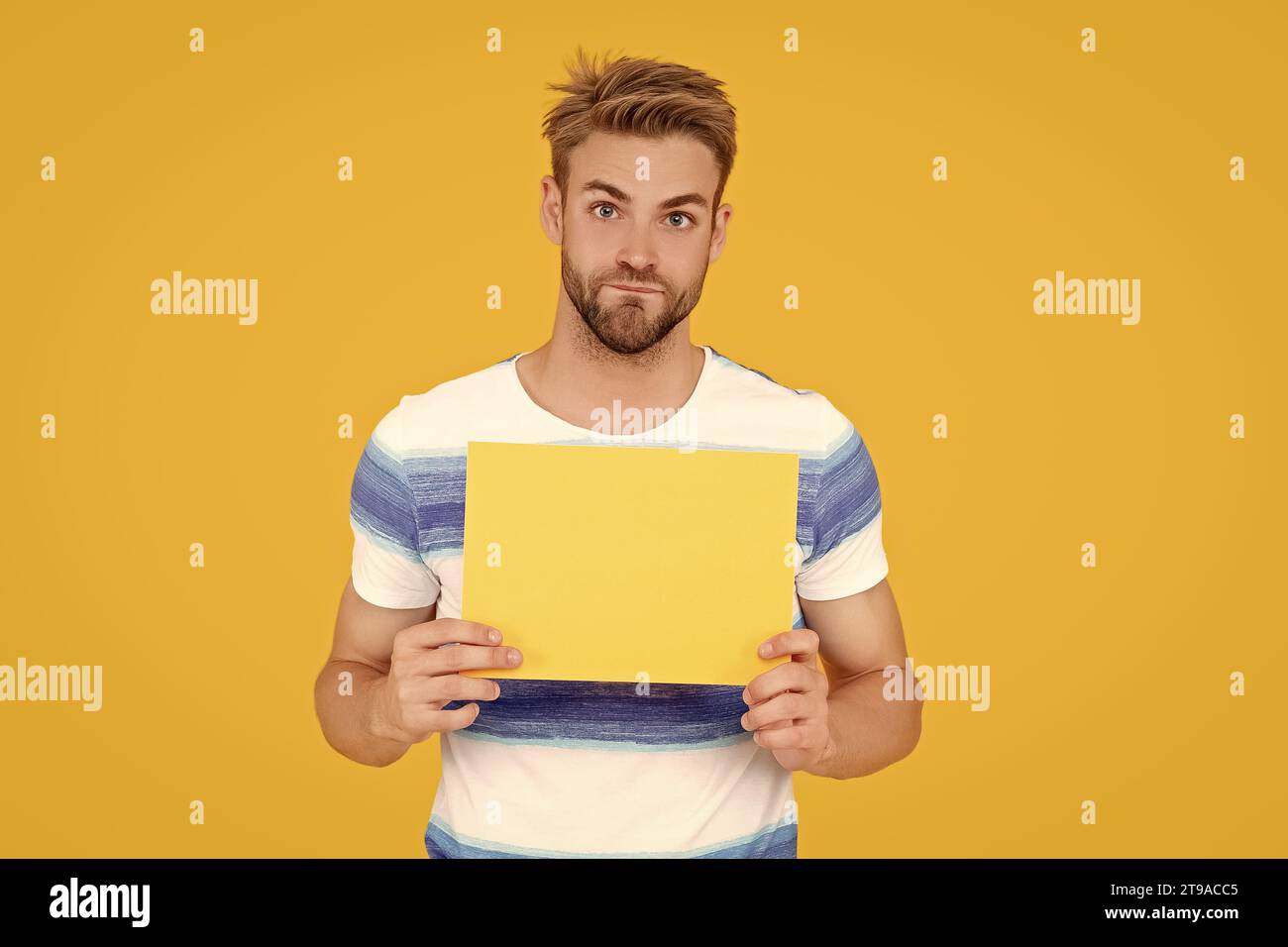 amazed man show advertisement and offer promotion isolated on yellow ...