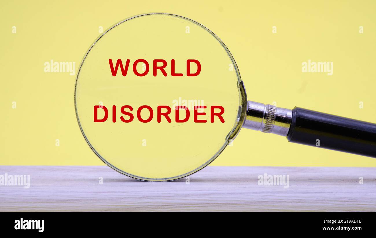 The phrase WORLD DISORDER lettering on through a magnifying glass on a ...