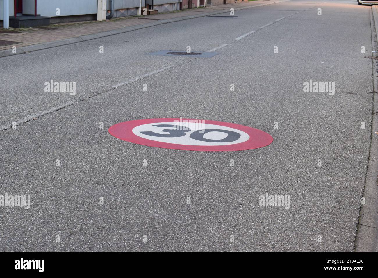 limit 30 sign painted on a French road Stock Photo - Alamy
