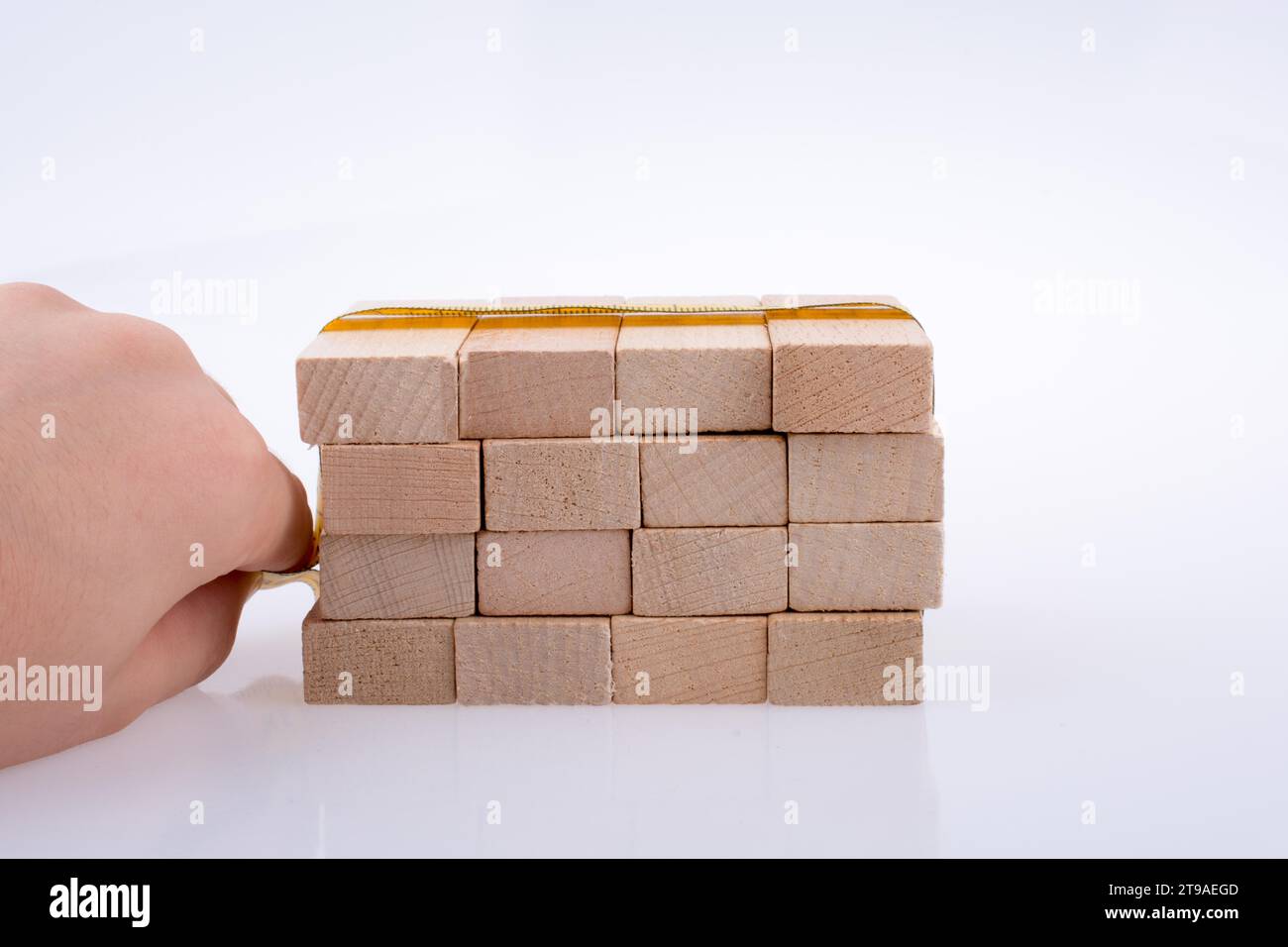 Yellow color measuring tape around domino pieces Stock Photo - Alamy