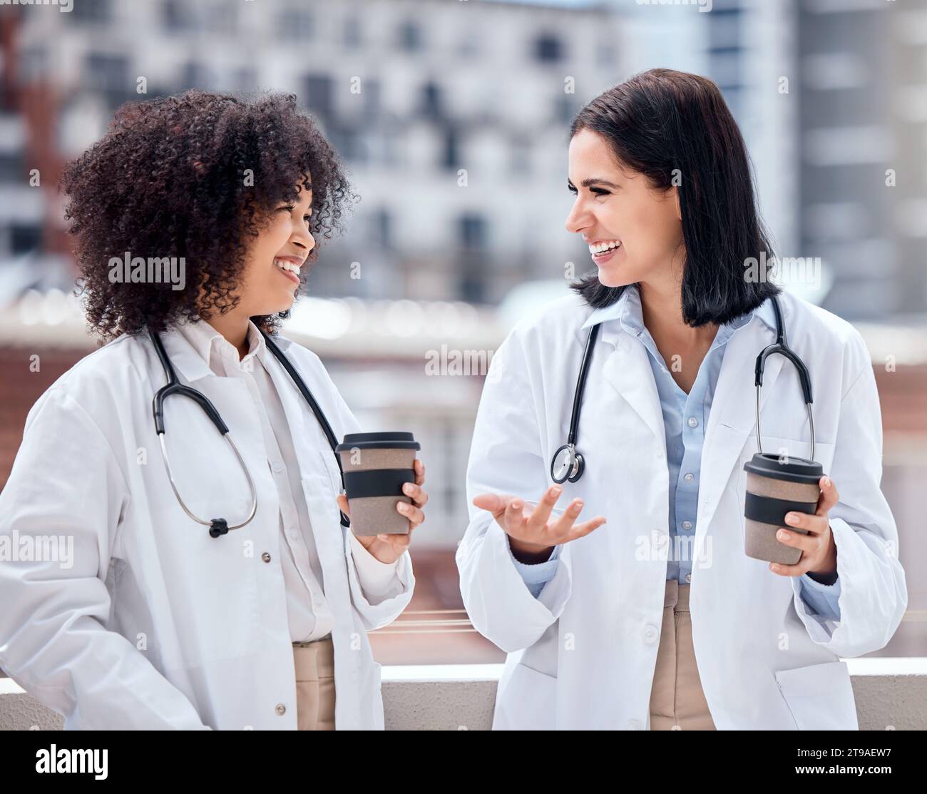 Conversation, coffee and young women doctors talking on medical ...
