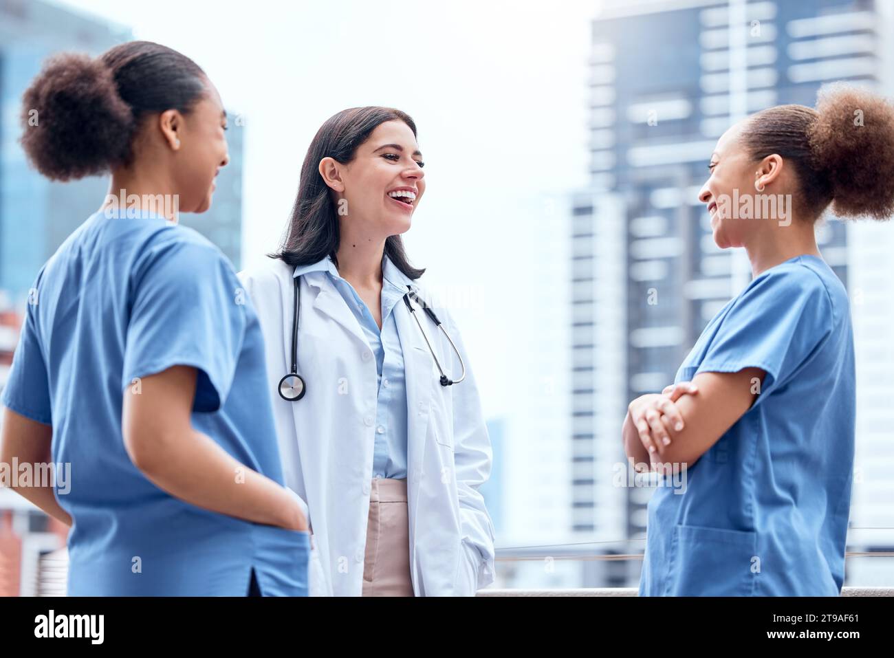 Medical, doctor and nurse outdoor with laughing for support, trust and collaboration at hospital ...
