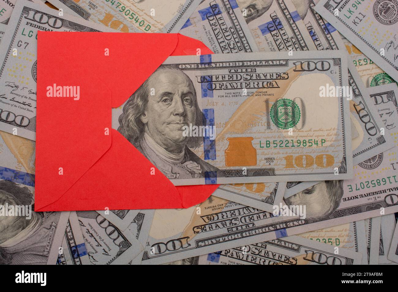 Little red envelope is placed on spread US dollar Banknotes Stock Photo ...