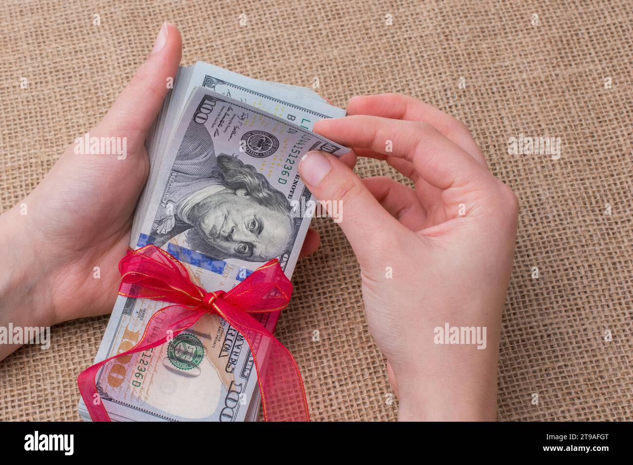 Banknote bundle of US dollar tied with colorful a ribbon Stock Photo ...