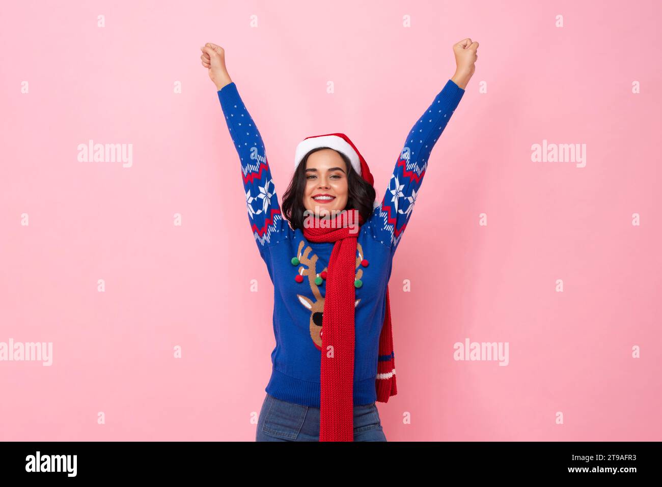 Festive portrait of joyful woman wearing Christmas sweater and hat ...
