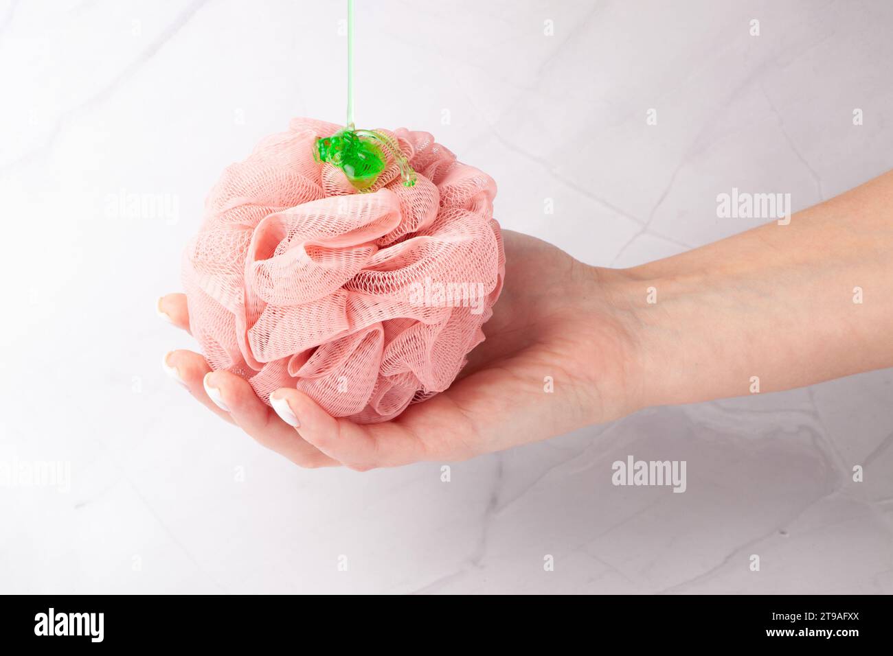 shampoo is flowing on the bath sponge in the female hand Stock Photo ...