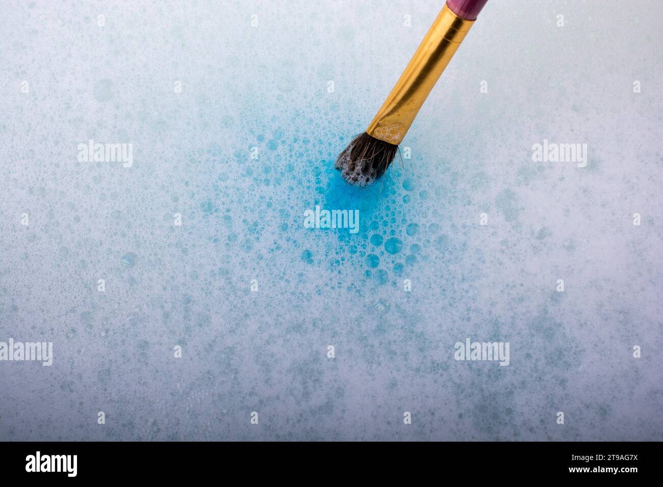 Paint dissolving in water as painting brush touching water Stock Photo ...
