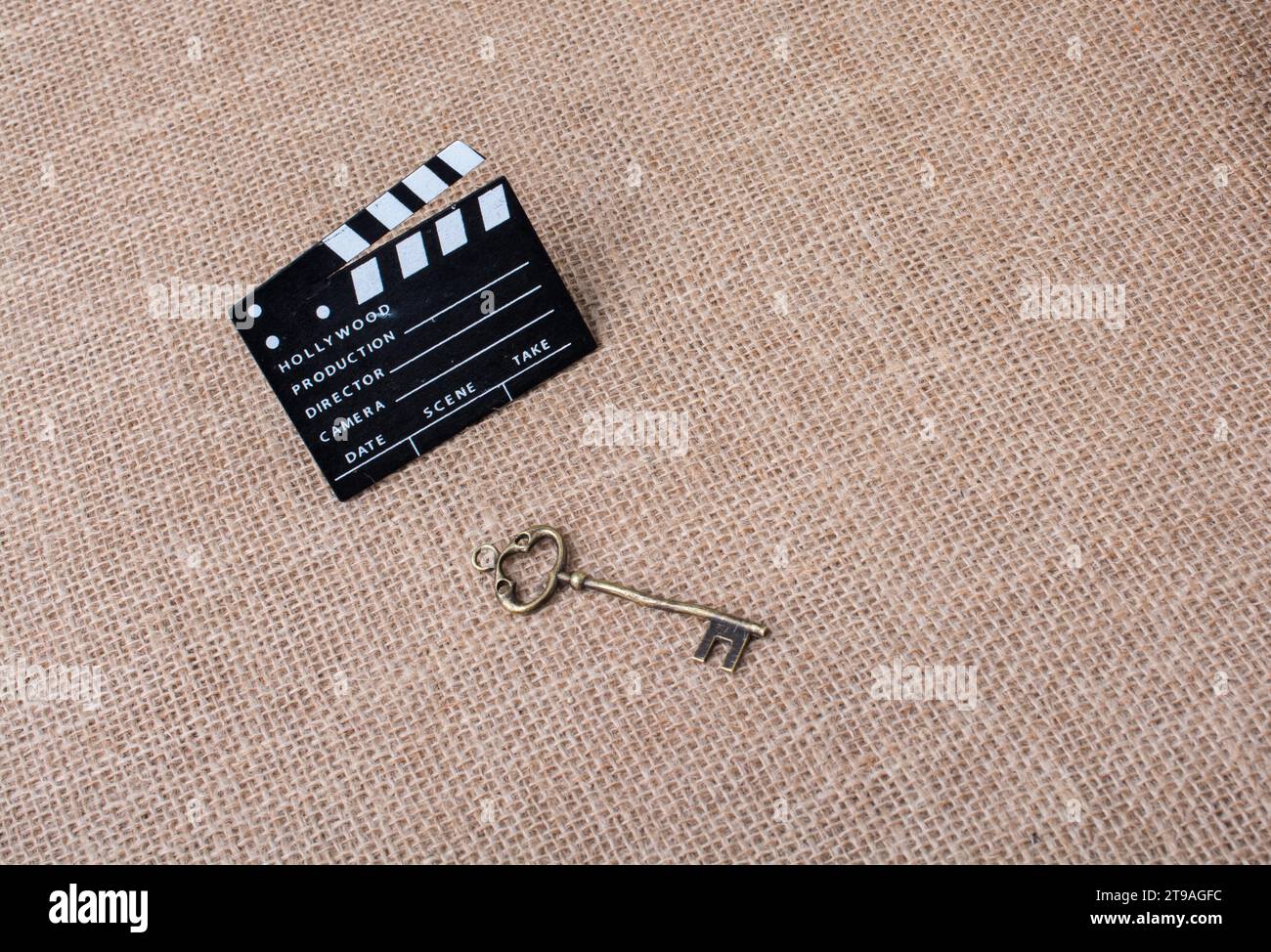 Movie clapper and retro key on canvas background Stock Photo - Alamy