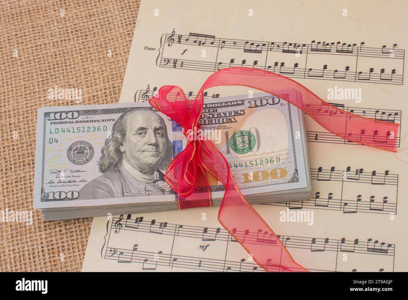 Banknote bundle of US dollar tied with colorful a ribbon Stock Photo ...