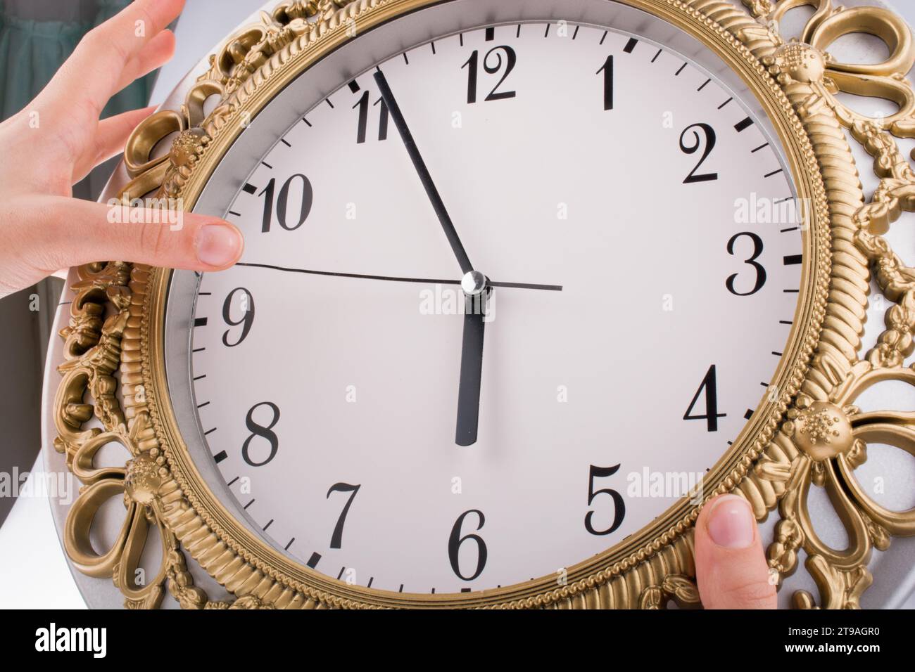 Hand in touch with a clock on a white background Stock Photo - Alamy