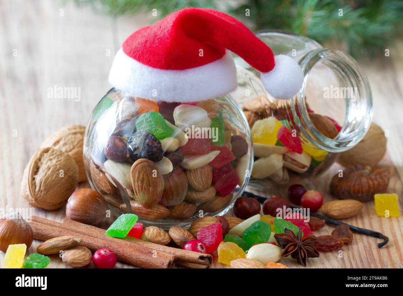 Christmas mix of nuts and dried fruit in glass jar with santa hat ...