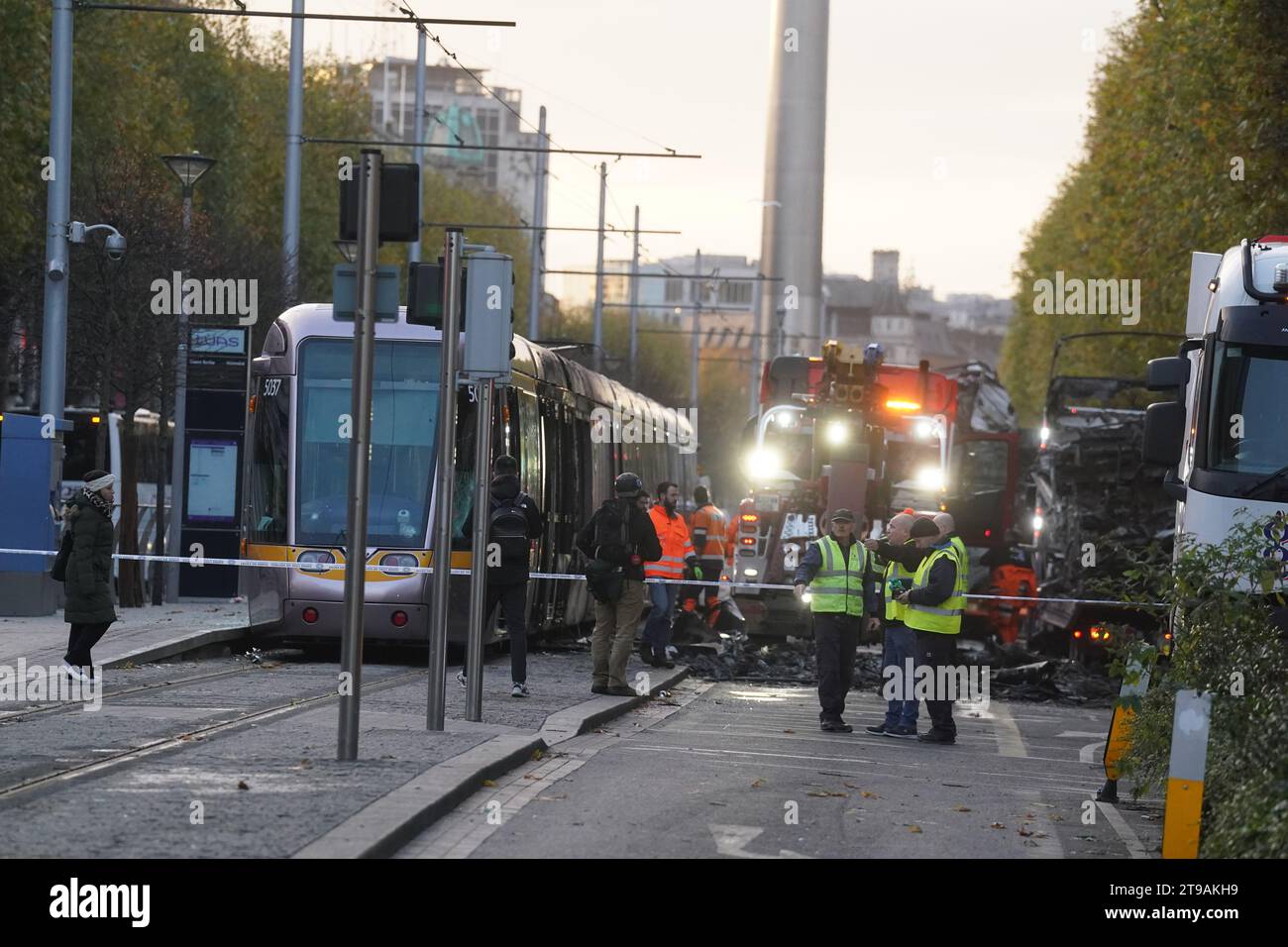 Debris is cleared from a burned out Luas and bus on O'Connell Street in ...