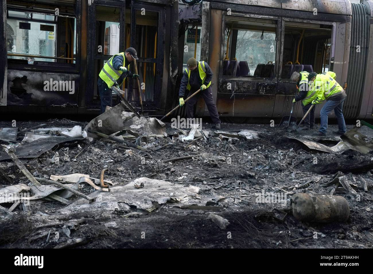 Debris is cleared from a burned out Luas and bus on O'Connell Street in ...