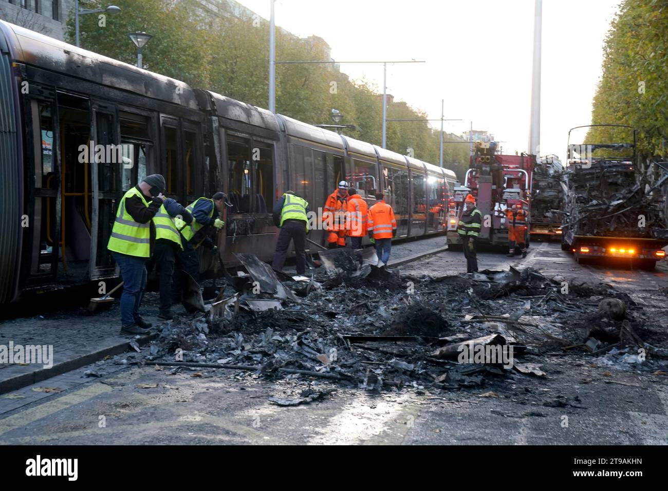 Debris is cleared from a burned out Luas and bus on O'Connell Street in ...
