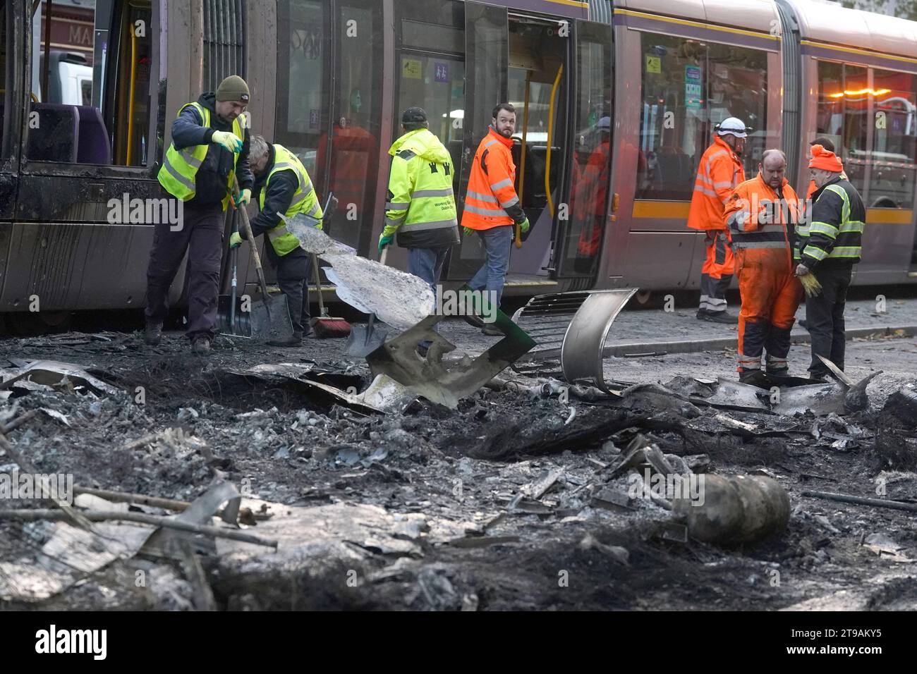 Debris is cleared from a burned out Luas and bus on O'Connell Street in ...