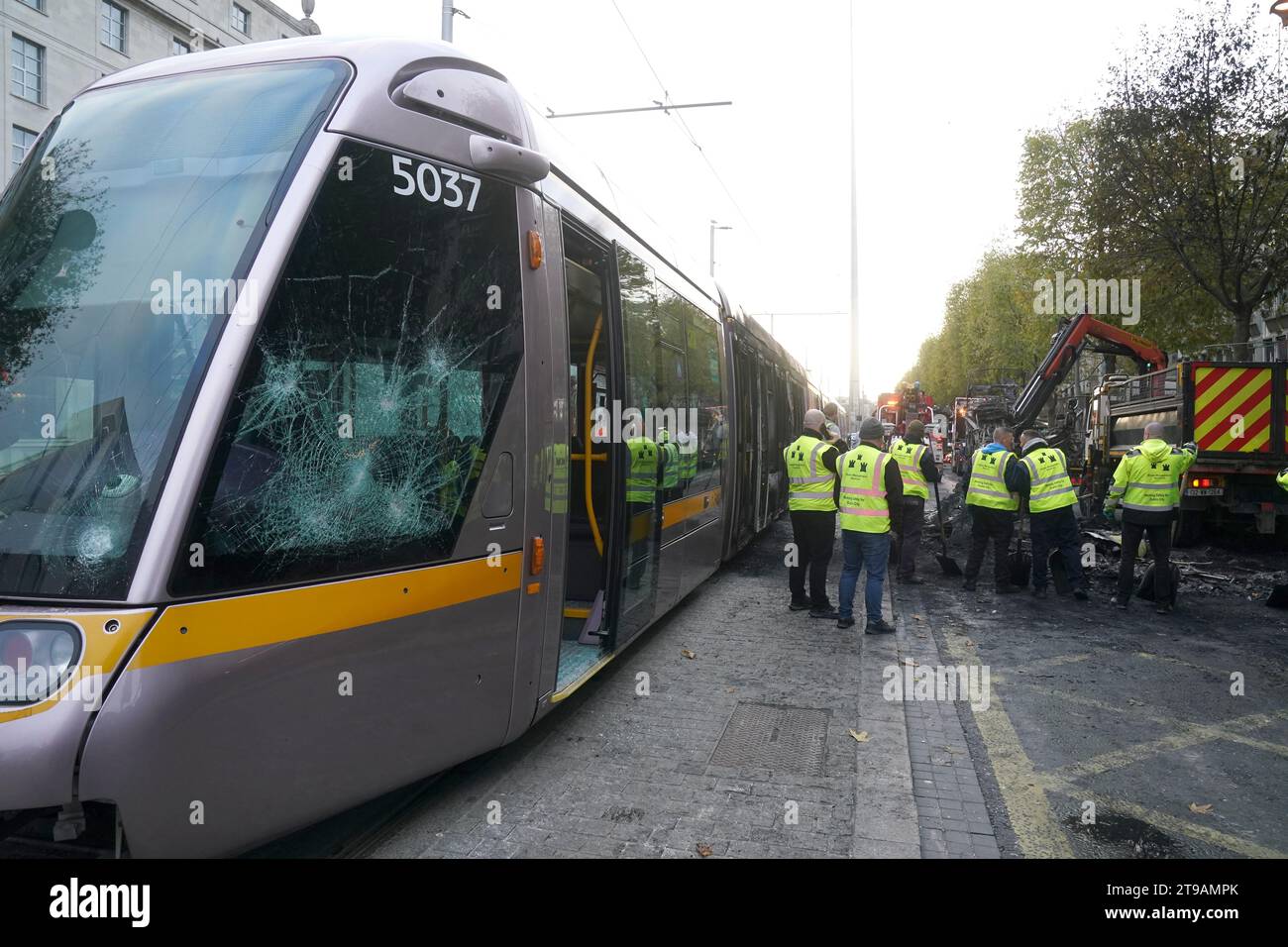 Workers clear debris next to a damaged Luas on O'Connell Street in ...