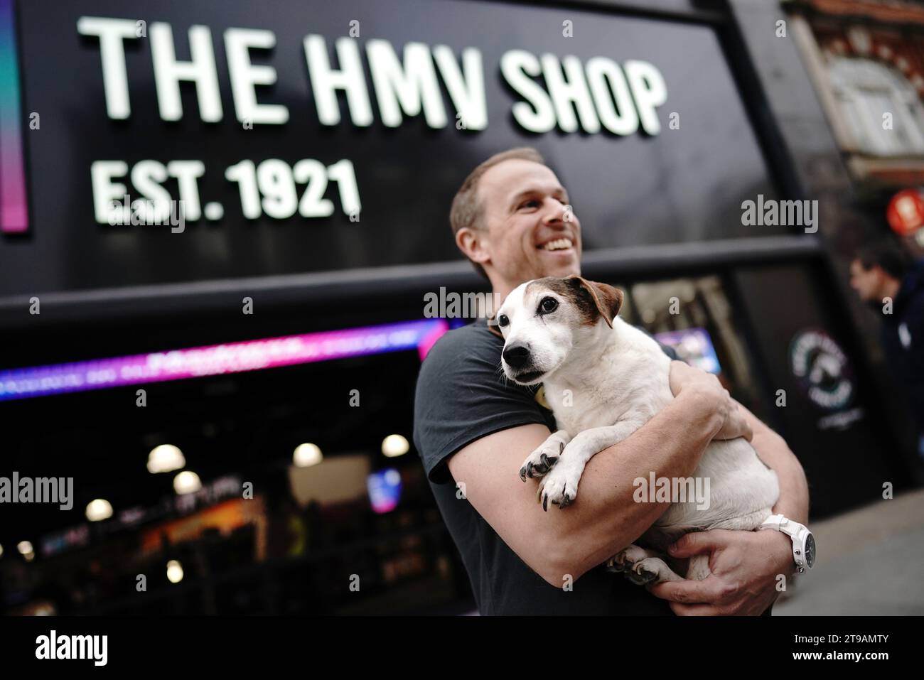 Owner of HMV, Doug Putman, with the dog Holly outside the new HMV store ...