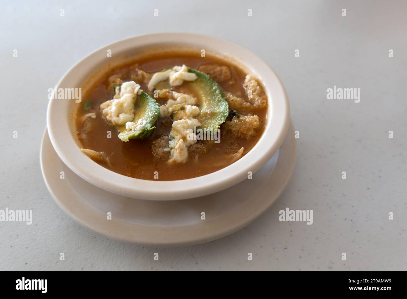 A Mexican aztec soup with chicharron avocado cheese and tortilla Stock ...