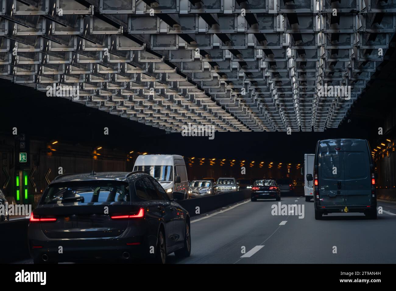 Driving in tunnel in heavy traffic on ring road of capital of France ...