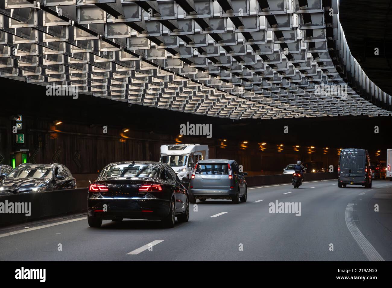 Driving in tunnel in heavy traffic on ring road of capital of France ...