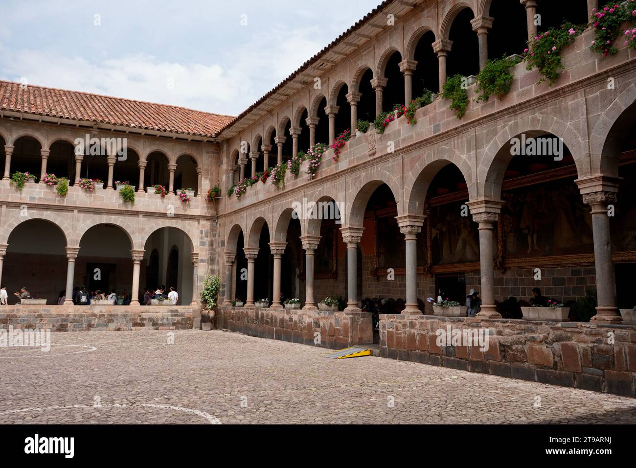 Stone arches surrounding the central courtyard of The Qorikancha or ...