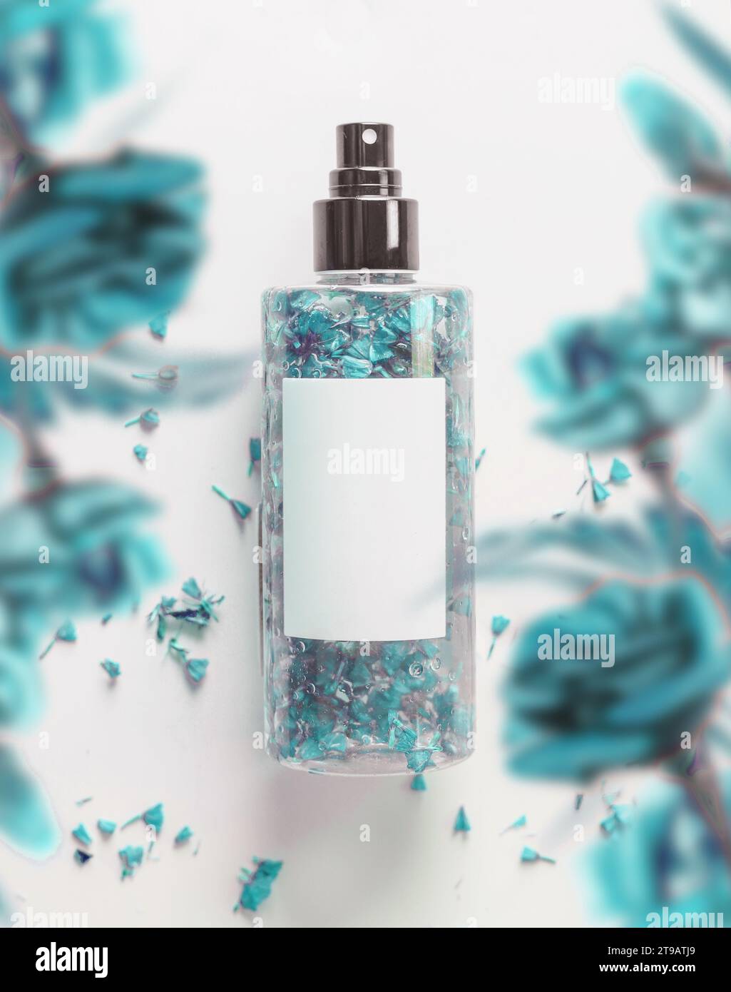 Natural perfume spray bottle with blue flowers at white background, top ...