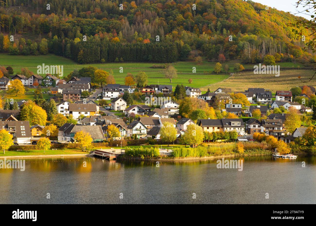 Beautiful german village with colorful foliage forest in the background ...