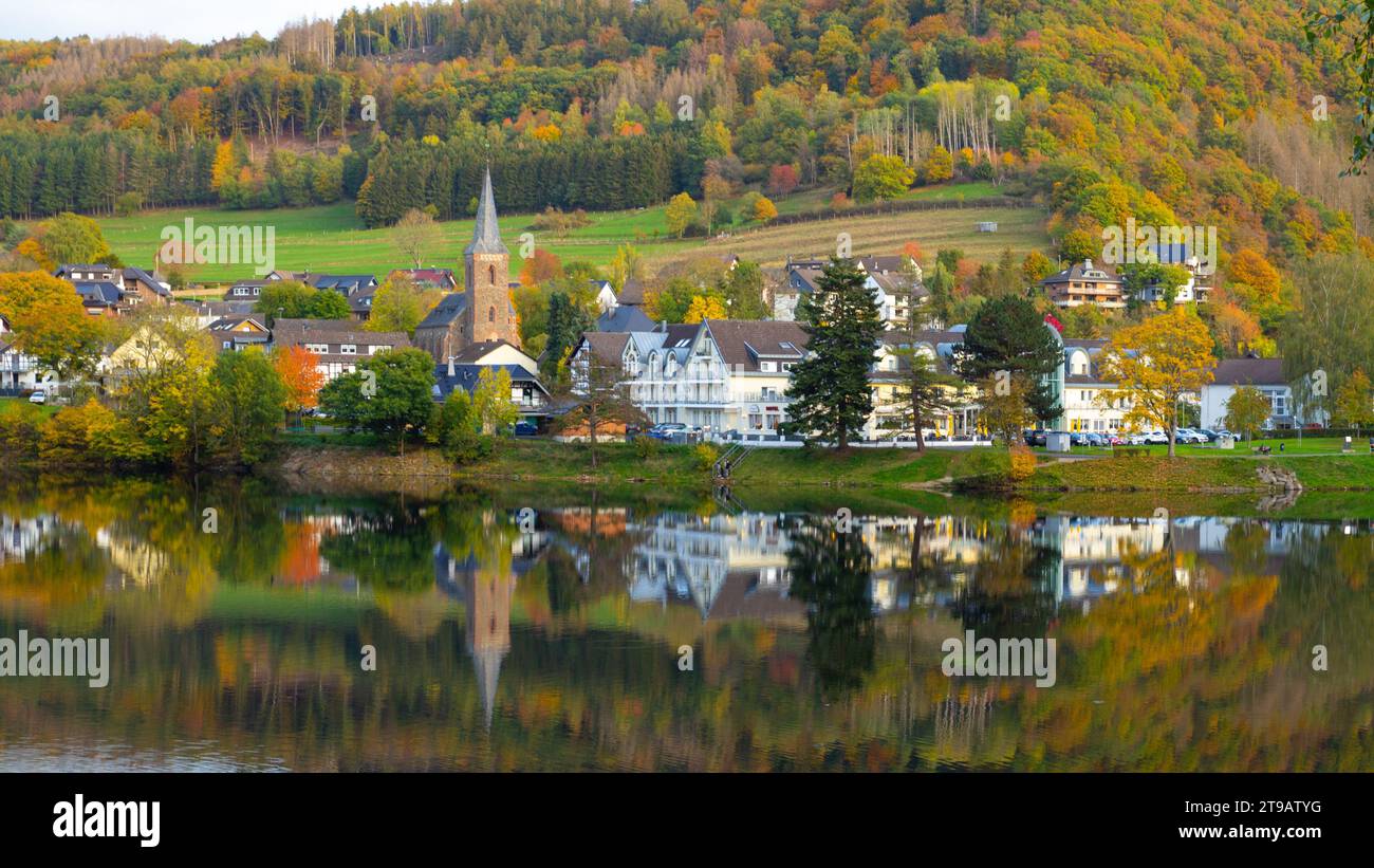 Beautiful german village with colorful foliage forest in the background ...