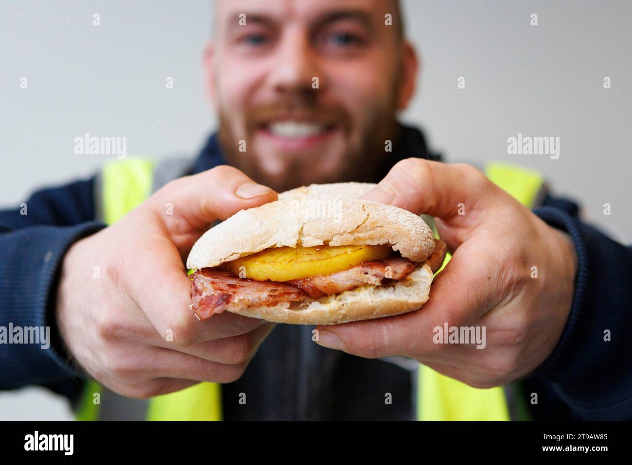 EDITORIAL USE ONLY George Simpson holding up a bacon sandwich that ...